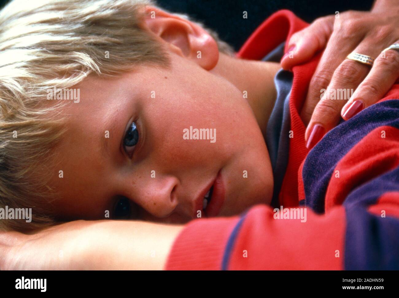 Sadness and depression. A sad or depressed looking boy is comforted by ...