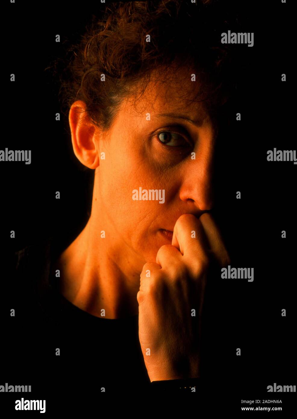 Anxiety. Face of a fearful and anxious woman holding her hand to her ...