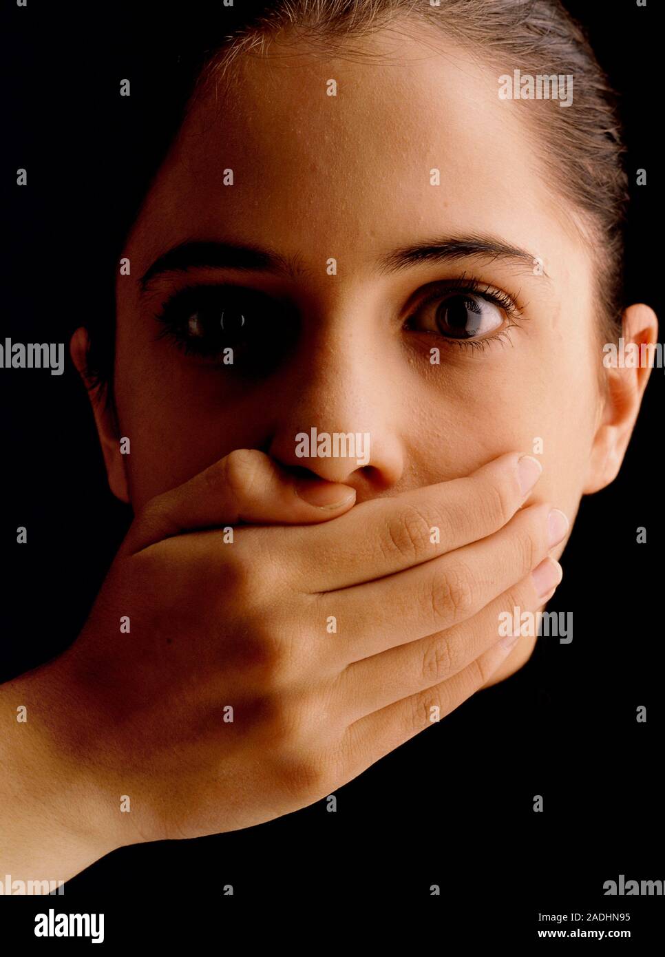 Autism. Abstract image of autism depicting a teenage girl with her hand ...