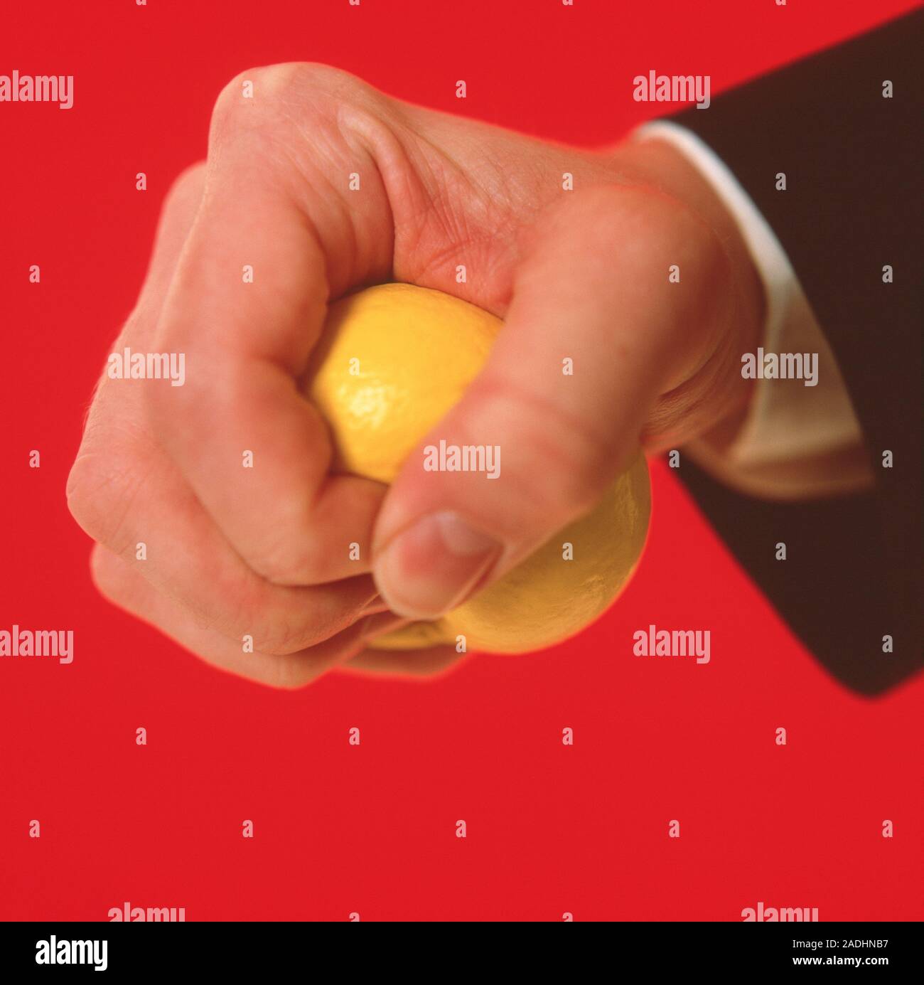 Stress. Hand of a stressed man squashing a stress ball. The ...