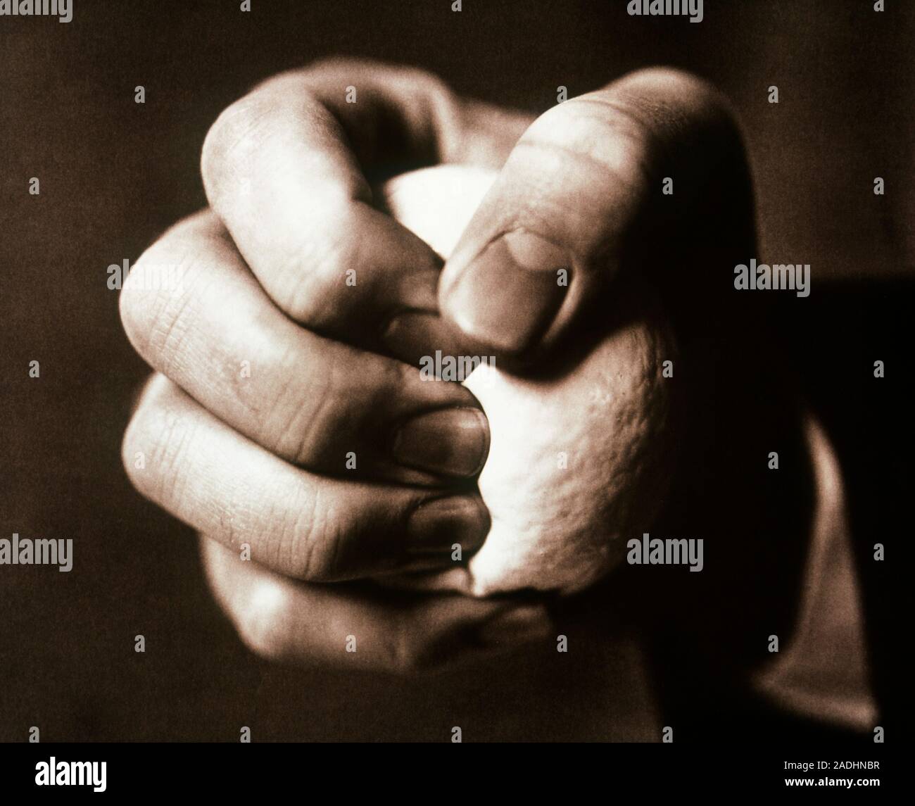 Stress. Hand of a stressed man squashing a stress ball. The ...