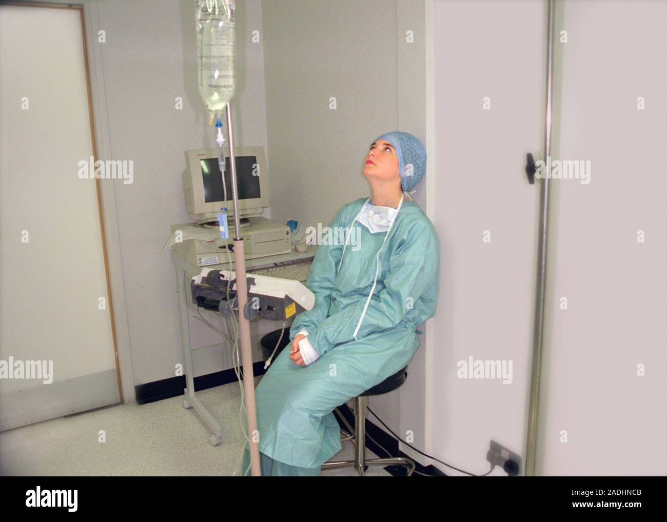 Tired surgeon resting on a chair in an operating theatre Stock Photo ...