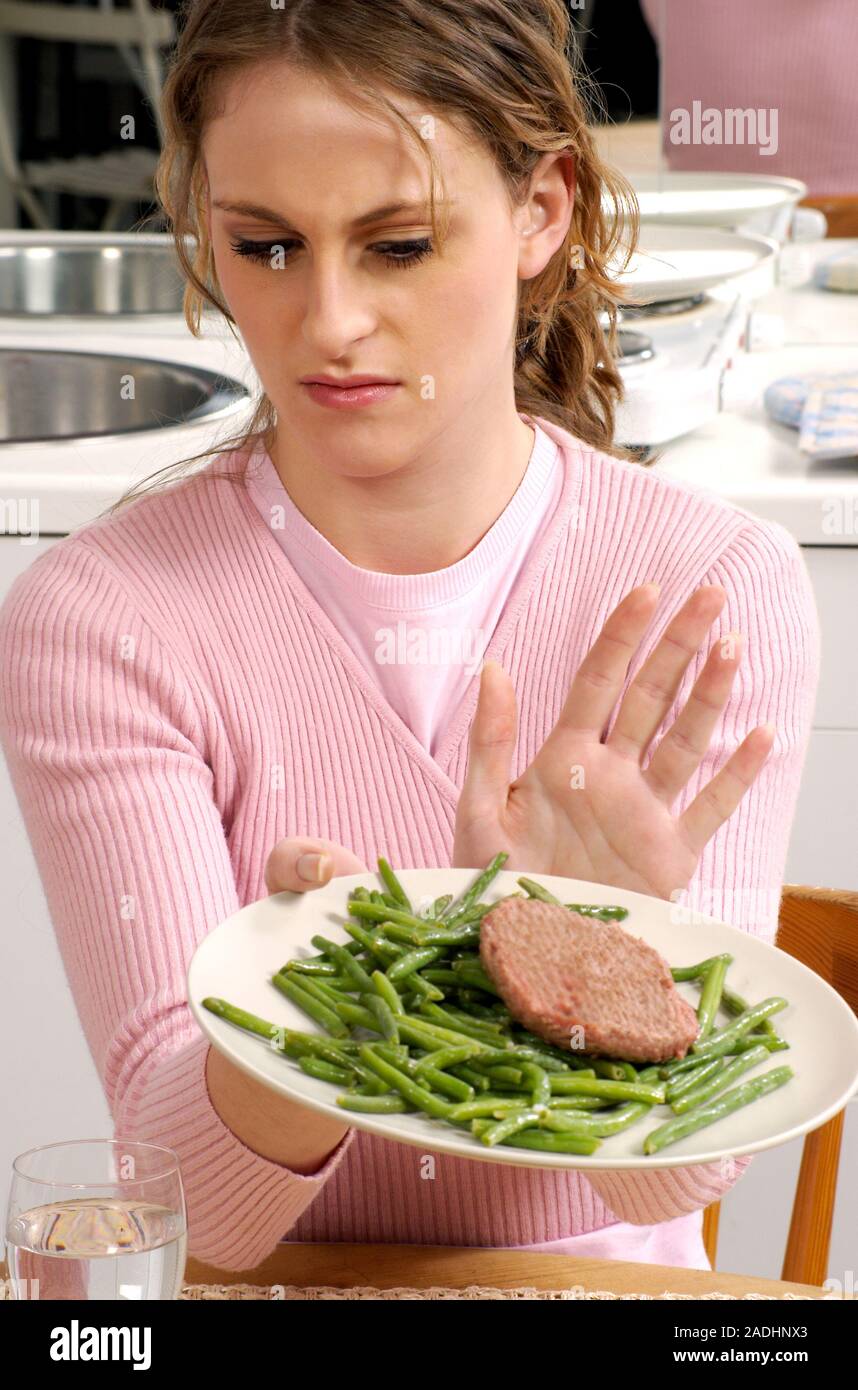 MODEL RELEASED. Woman rejecting a plate of food Stock Photo - Alamy