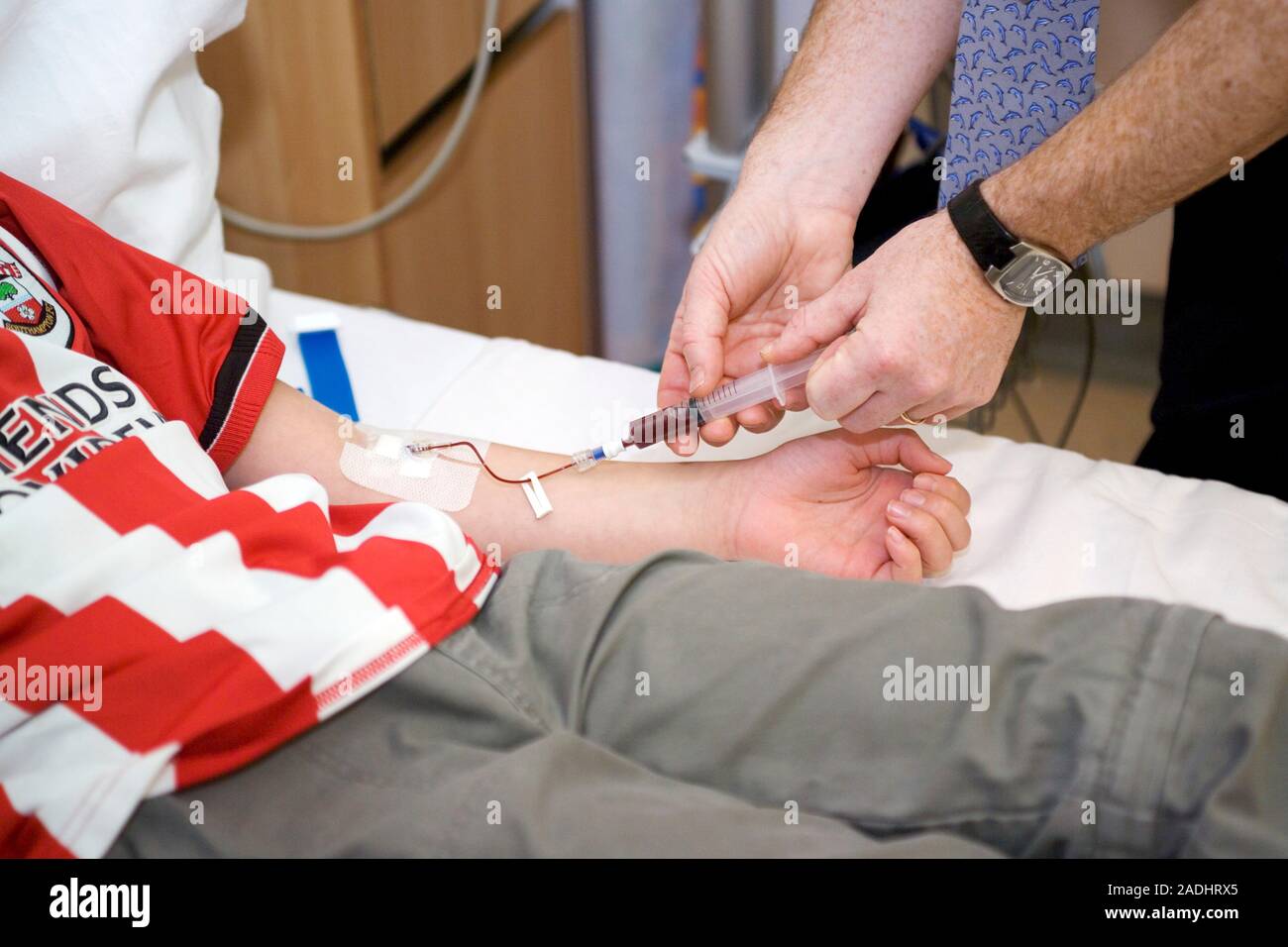 MODEL RELEASED. RAST blood test. Doctor taking blood from the arm of a ...