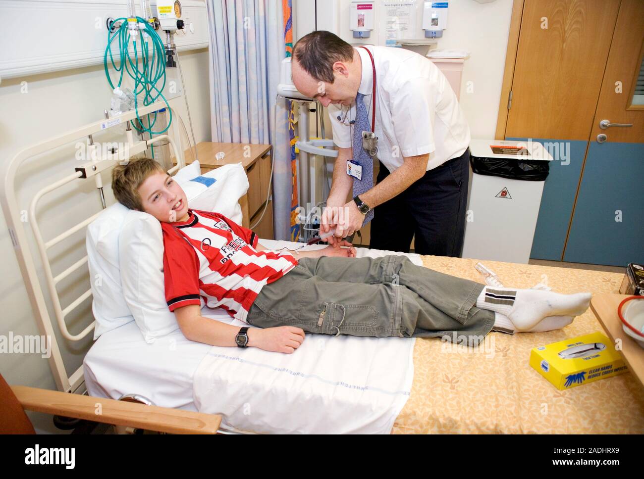 MODEL RELEASED. RAST blood test. Doctor taking blood from the arm of a ...