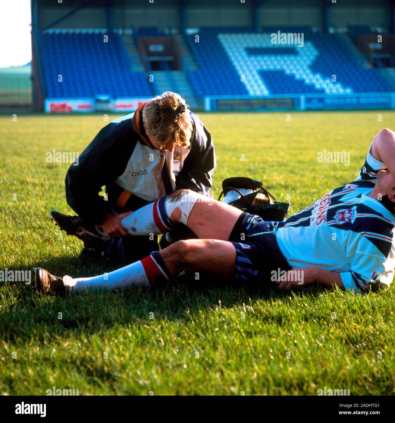 Sports injury. View of a female physiotherapist checking the strapping ...