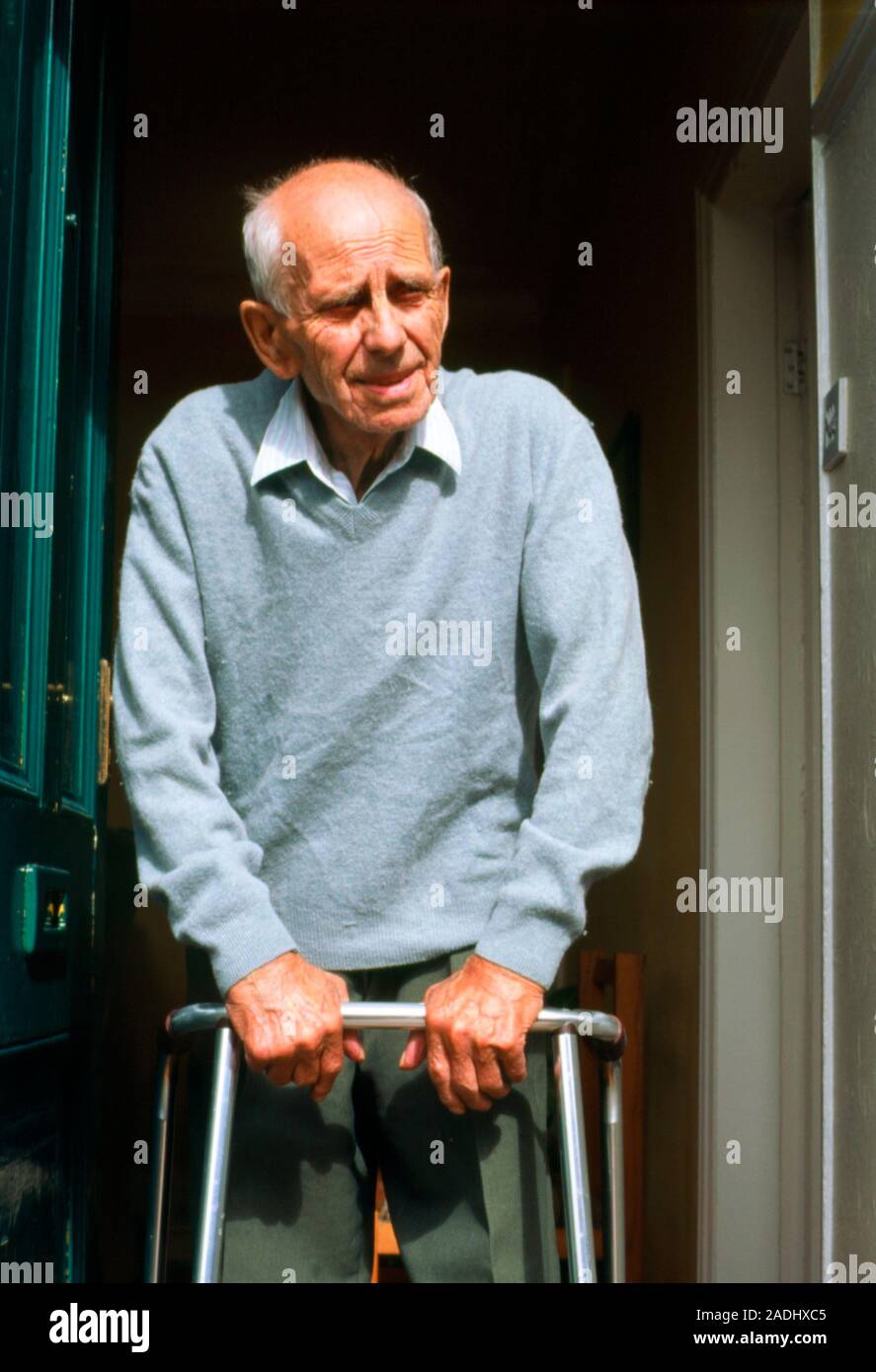 Elderly man. Elderly man standing in his doorway using a walking or ...