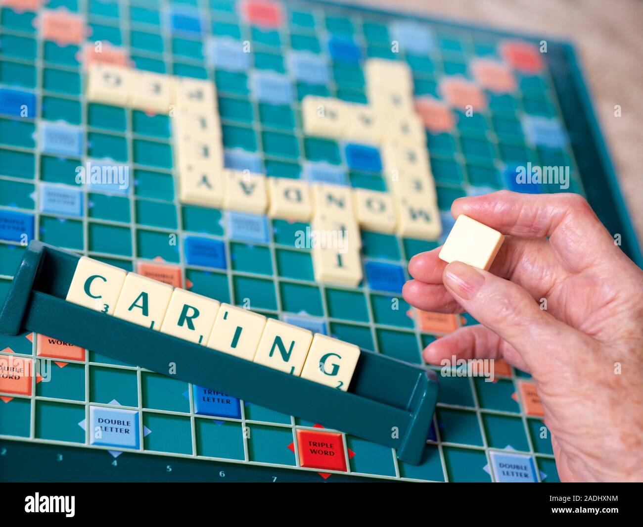 MODEL RELEASED. Geriatric care. Hand of a 83 year old woman playing ...