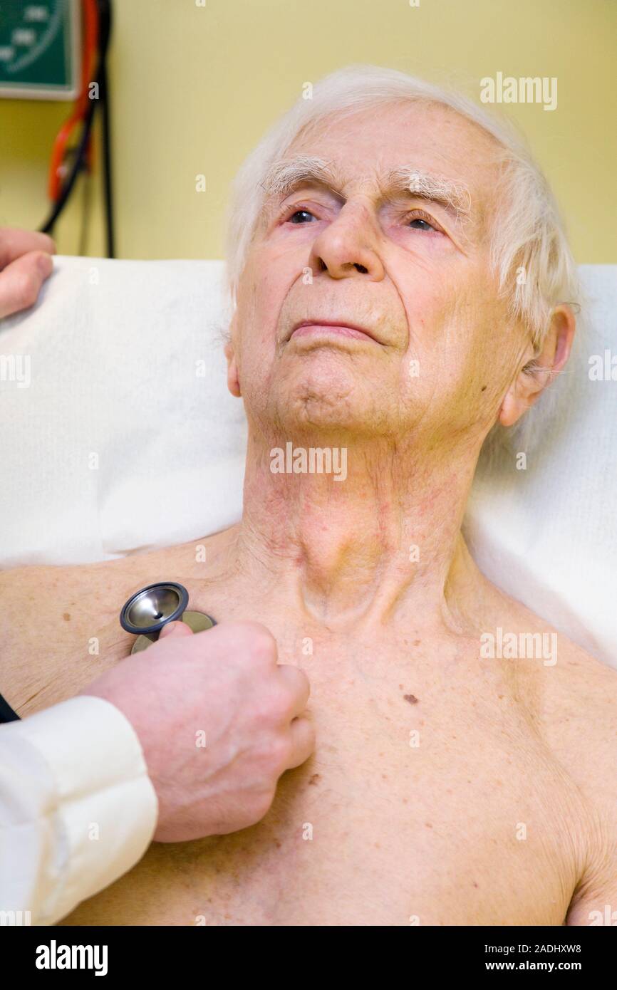 Chest examination. Doctor using a stethoscope to examine a 93 year old ...