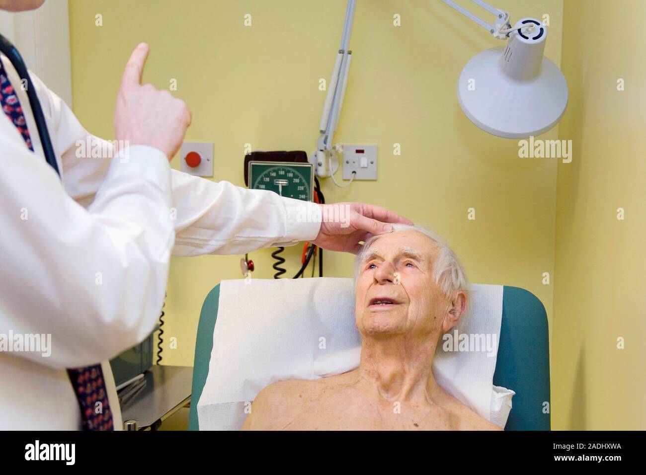 Neurological examination. Doctor performing the 'follow my finger' test ...