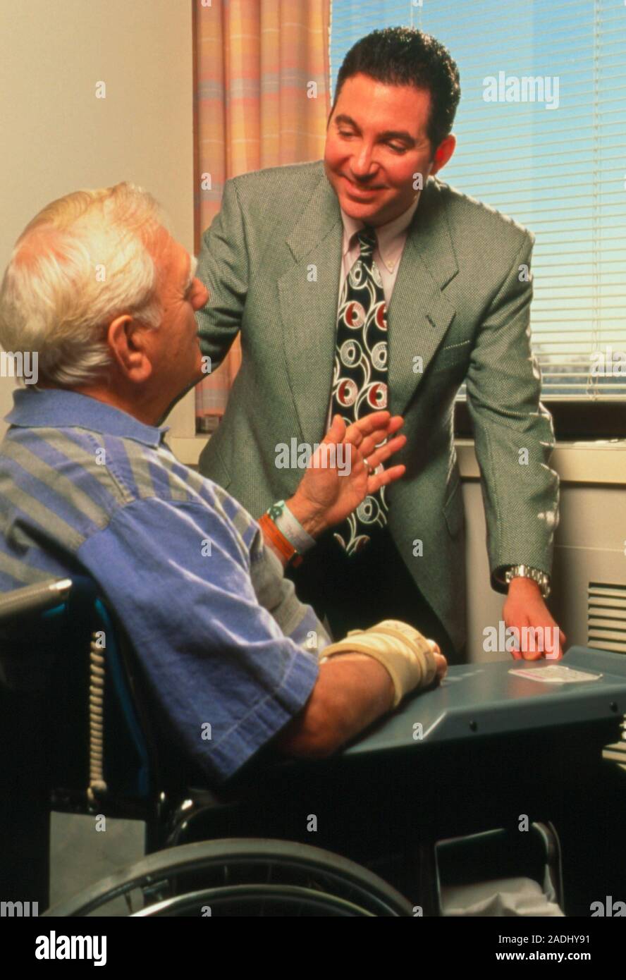 Disabled man & doctor. An elderly disabled man, confined to a ...