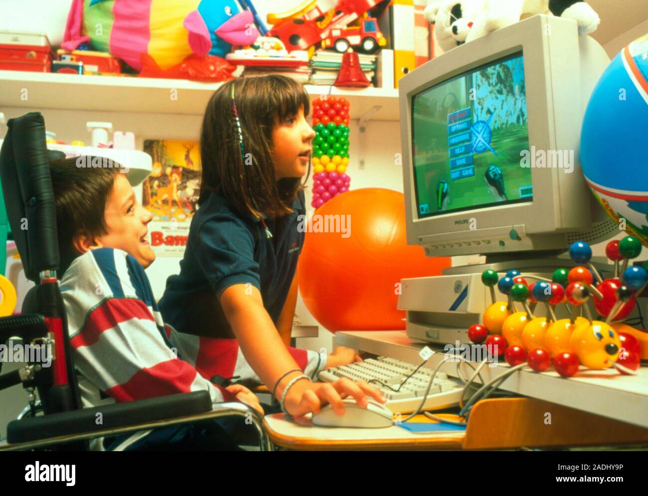 Brain-activated computer system. Disabled boy in a wheelchair using a ...