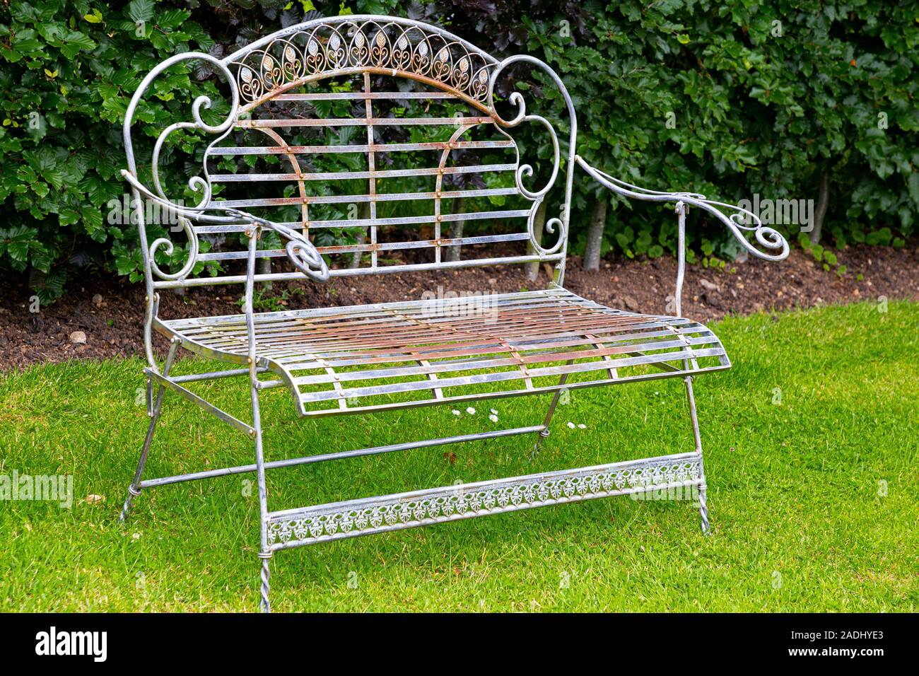 Wrought iron garden bench Stock Photo - Alamy