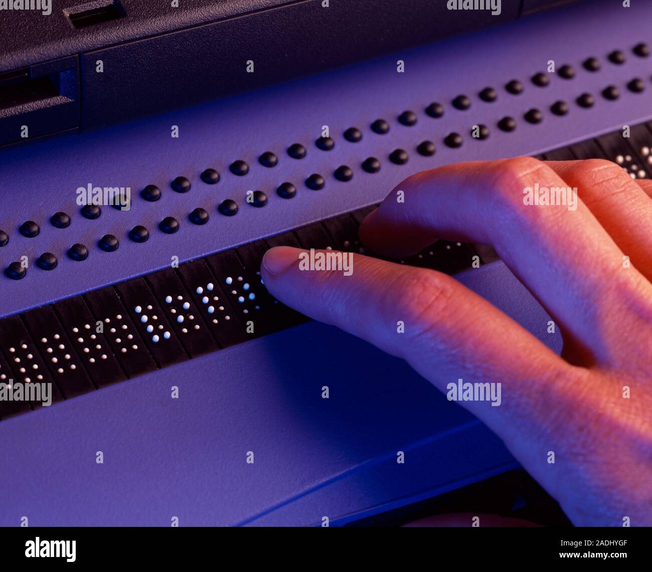 Electronic braille system. Close-up of a blind person reading braille ...