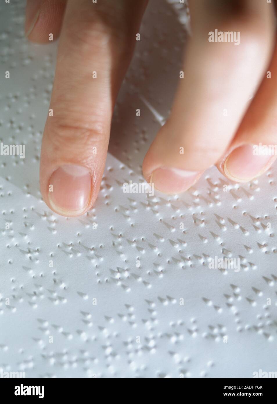 Braille. Hand of a blind person reading braille. The braille writing ...
