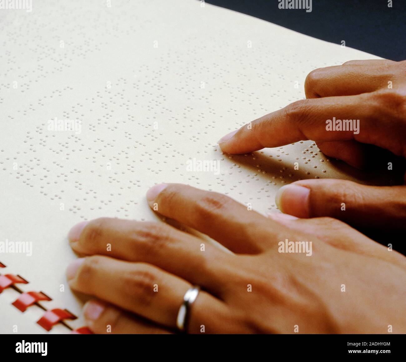 Braille. Hands of a blind person reading braille. The braille writing ...