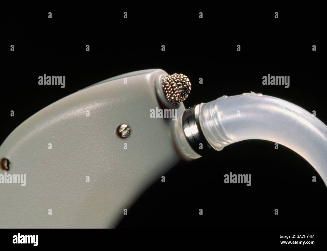 Microphone on hearing aid. Close-up of an air con- ductor hearing aid ...
