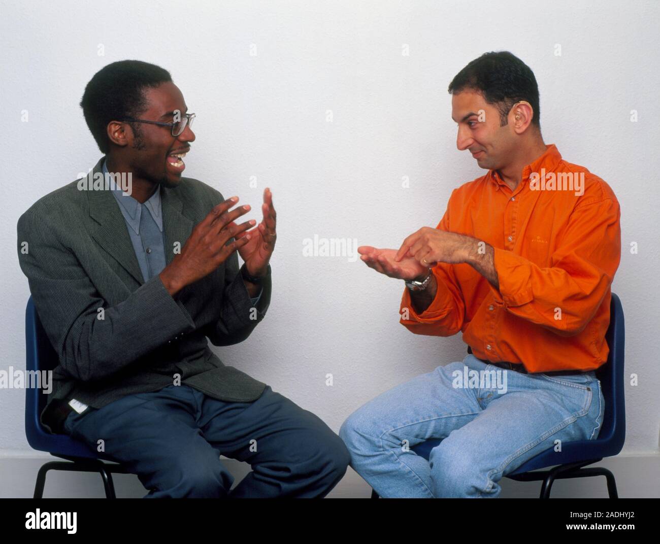 Sign language. Two deaf men using sign language. Each sign, made up of ...
