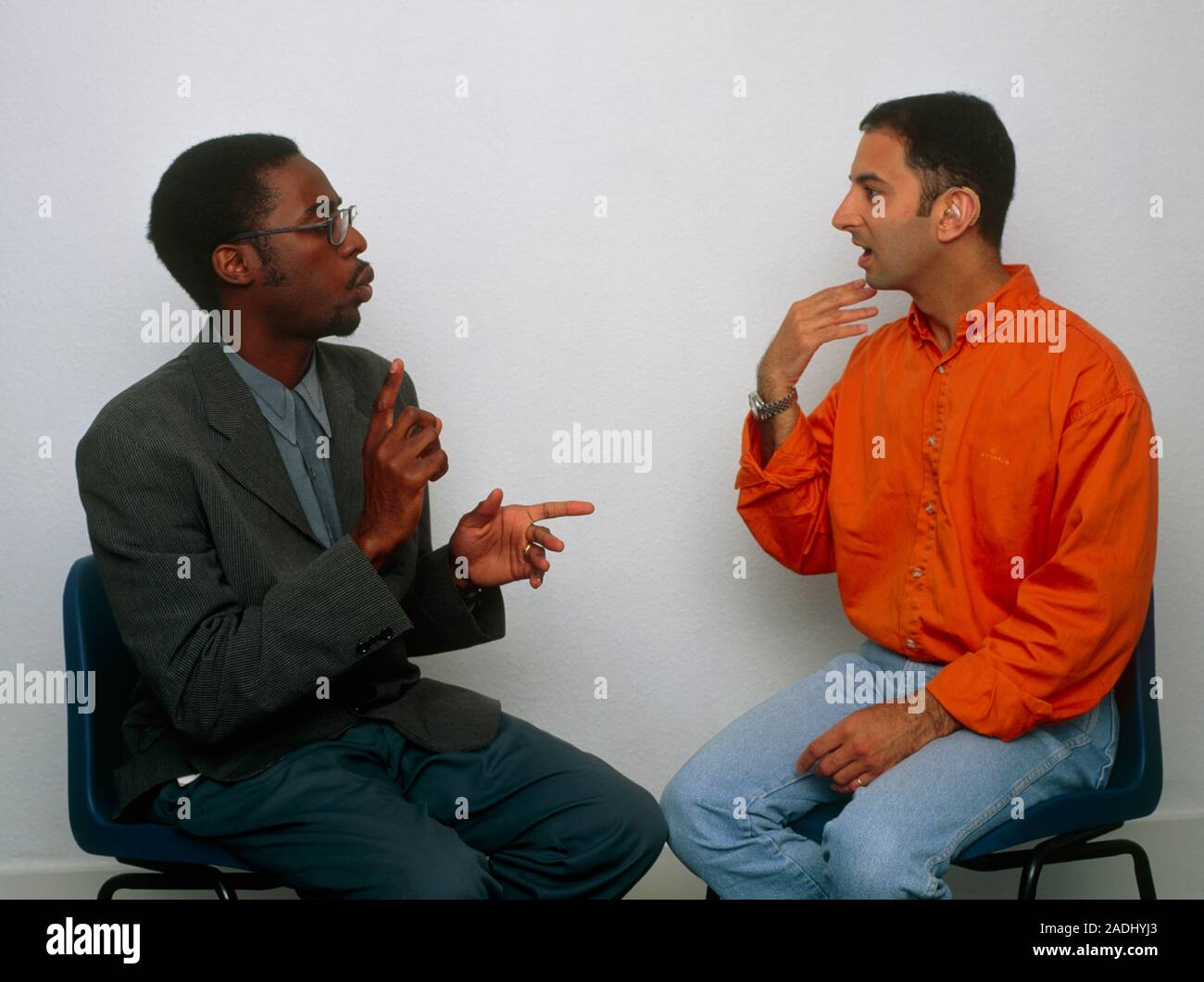 Sign language. Two deaf men using sign language. Each sign, made up of ...
