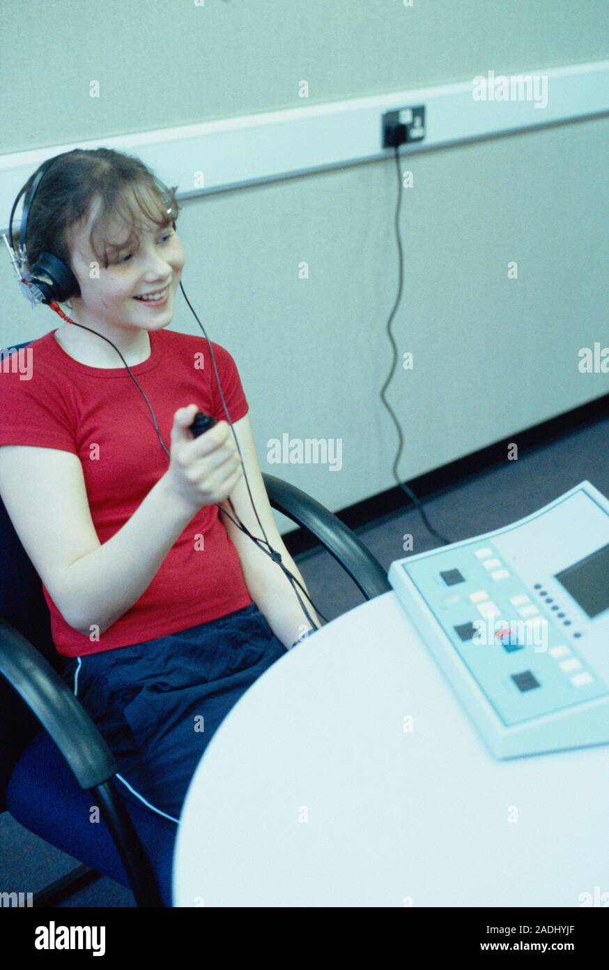 Pure-tone audiometry test. Teenage girl having the sensitivity of her ...