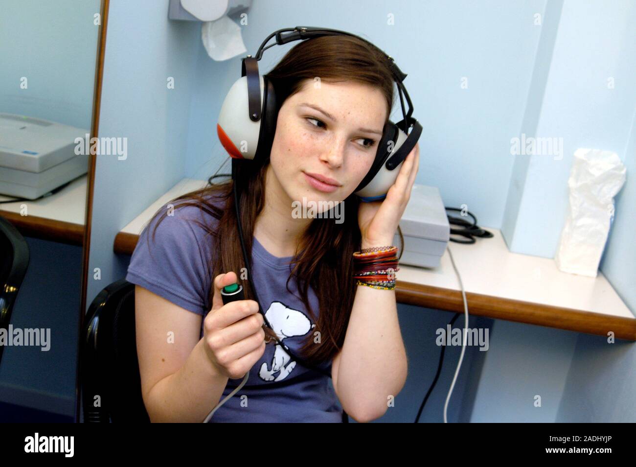 Hearing test. 15-year-old girl who is having her hearing tested. The ...