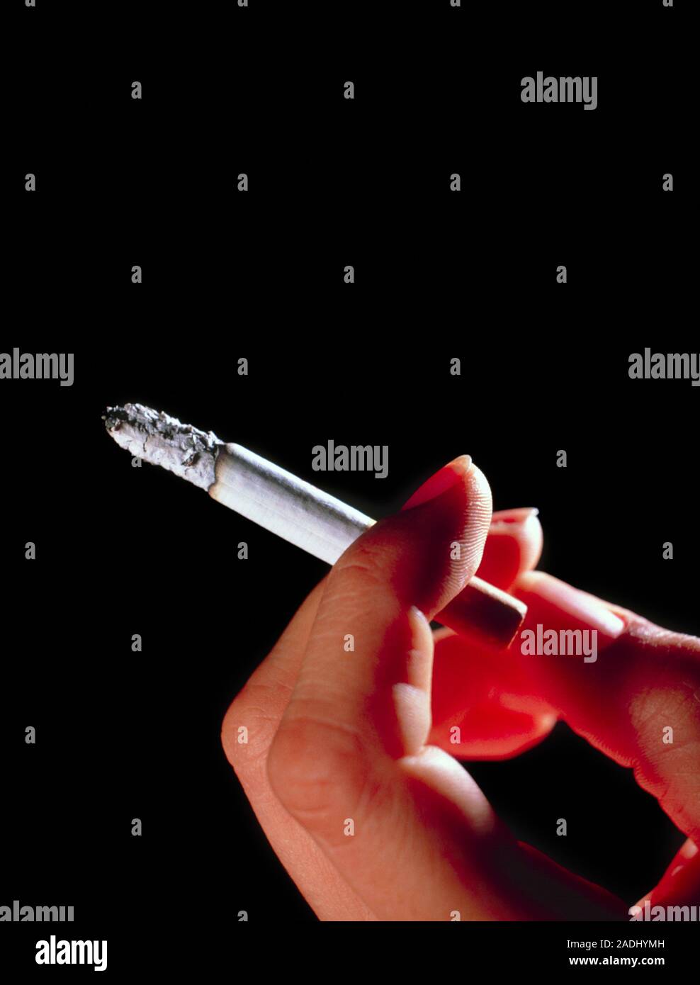 Smoking: hand holding cigarette Stock Photo - Alamy