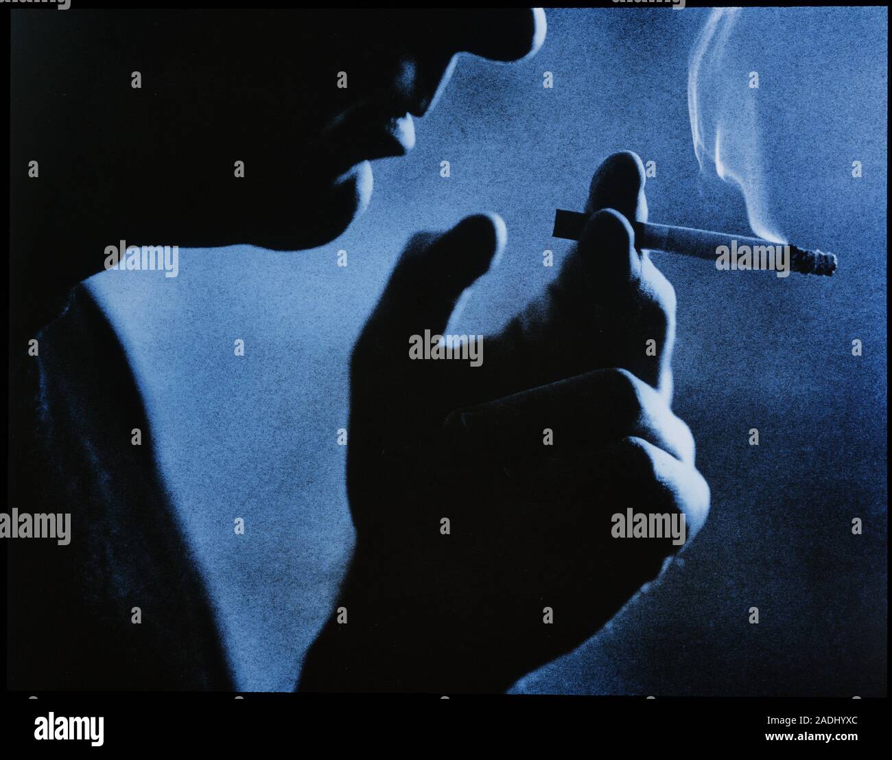 Cigarette smoking. Profile of a man smoking a cigarette. Nicotine in ...