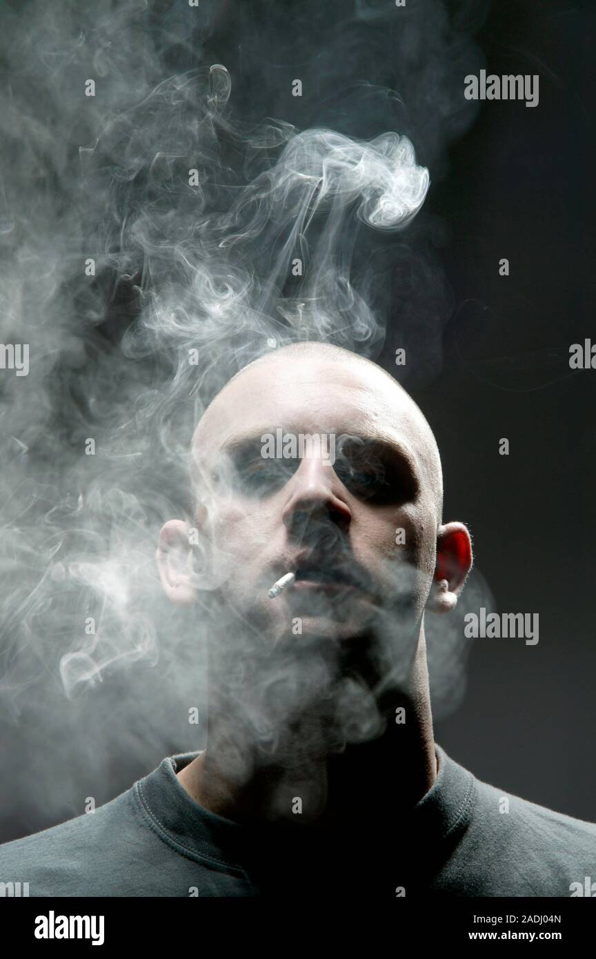 Smoking. Clouds of smoke surrounding the head of a cigarette smoker ...