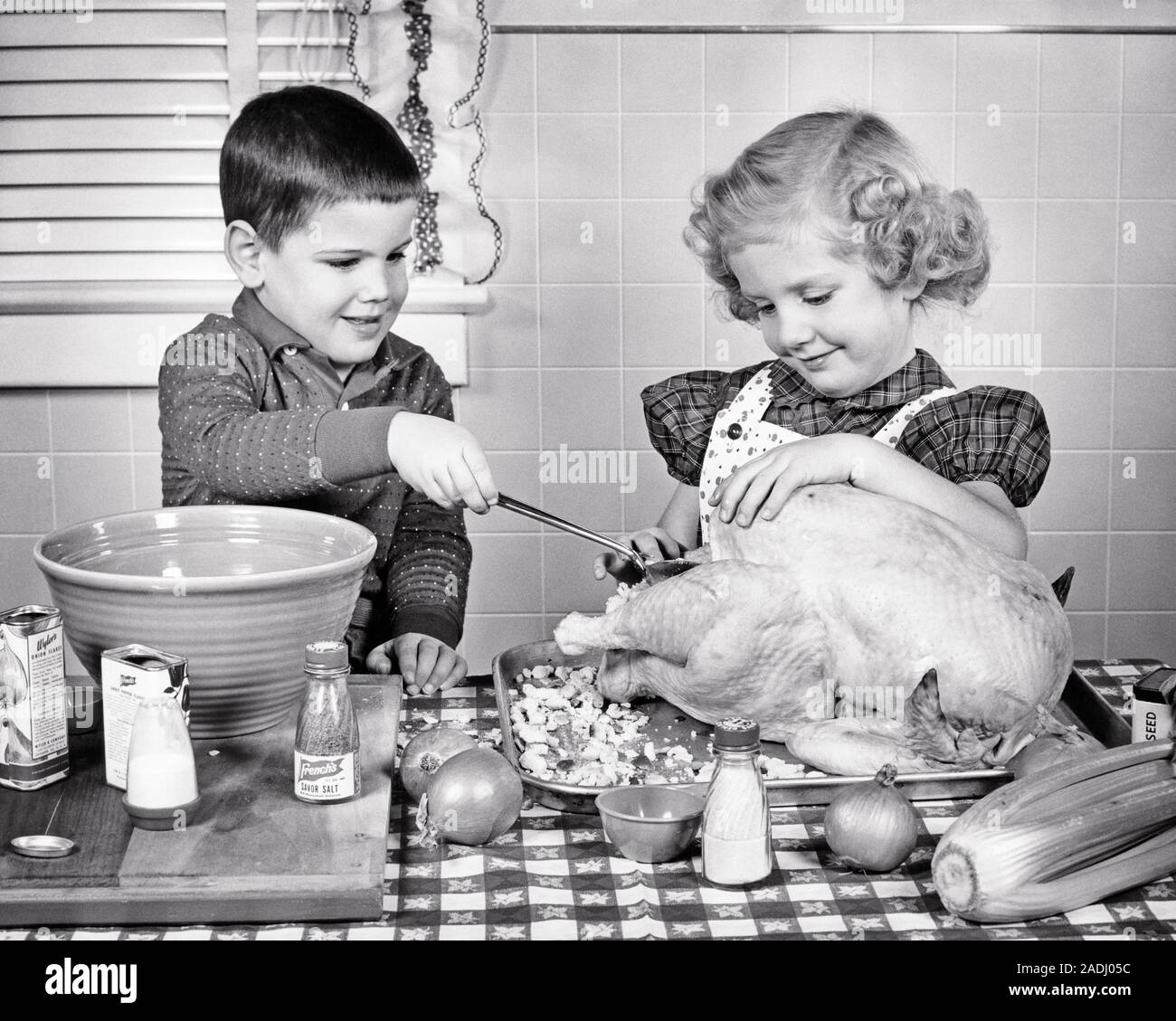 1950s SMILING BOY AND GIRL BROTHER AND OLDER SISTER LADLING BREAD ...