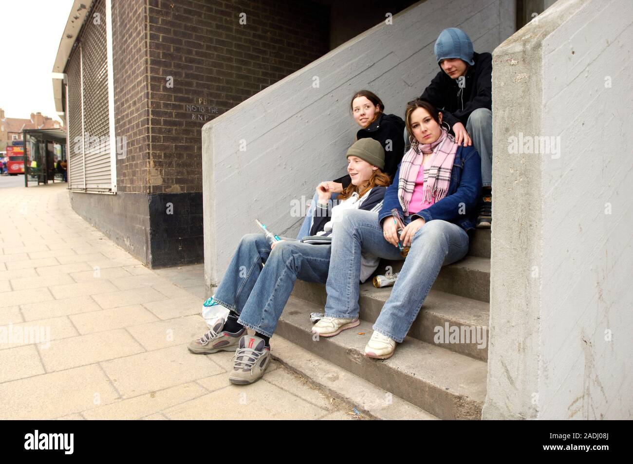 MODEL RELEASED. Underage drinking. Group of teenagers drinking on steps ...