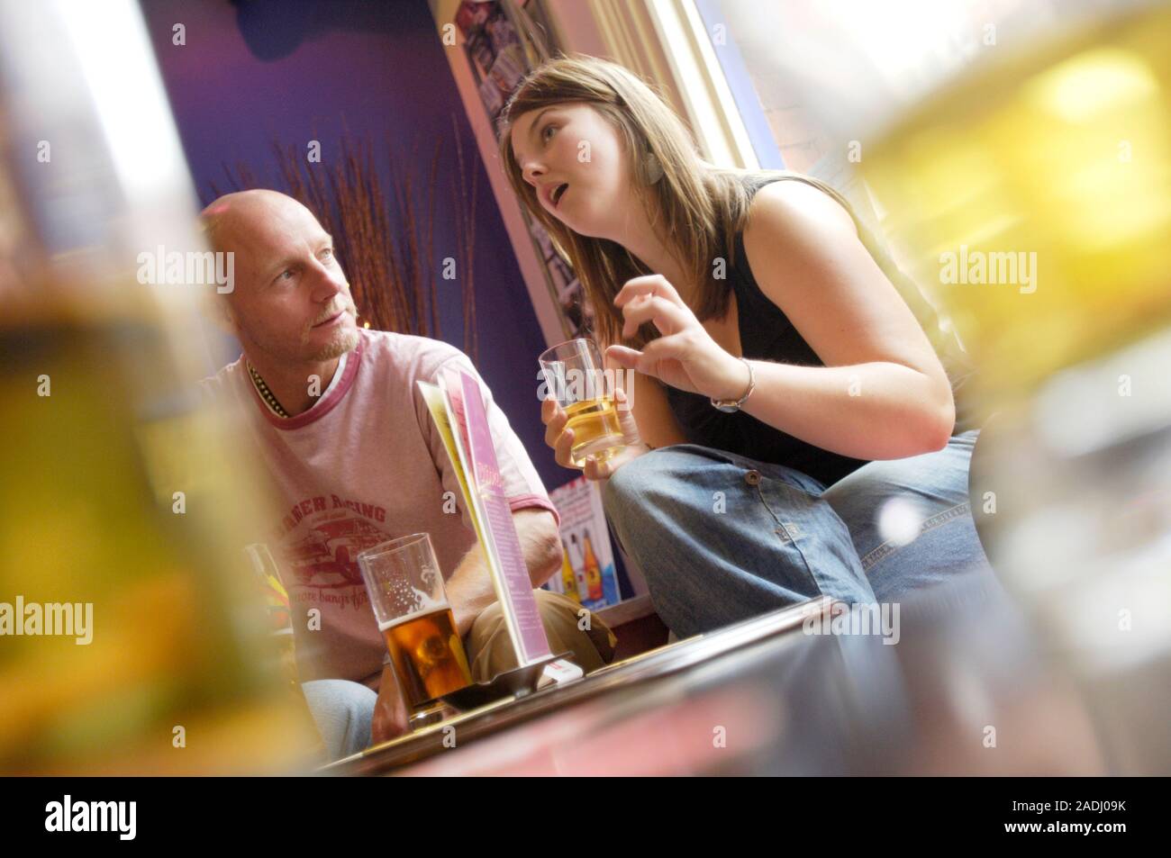 Drinking alcohol. Man and woman drinking alcoholic drinks in a pub ...