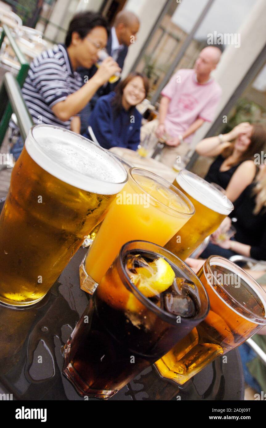 Social drinking. New round of drinks being brought to a group of ...