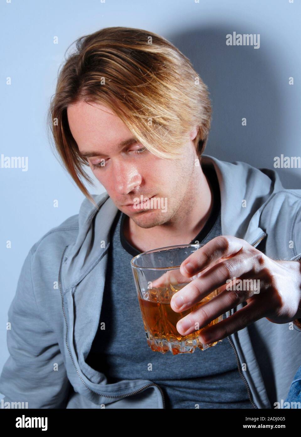 Alcoholic man drinking a glass of spirits Stock Photo - Alamy