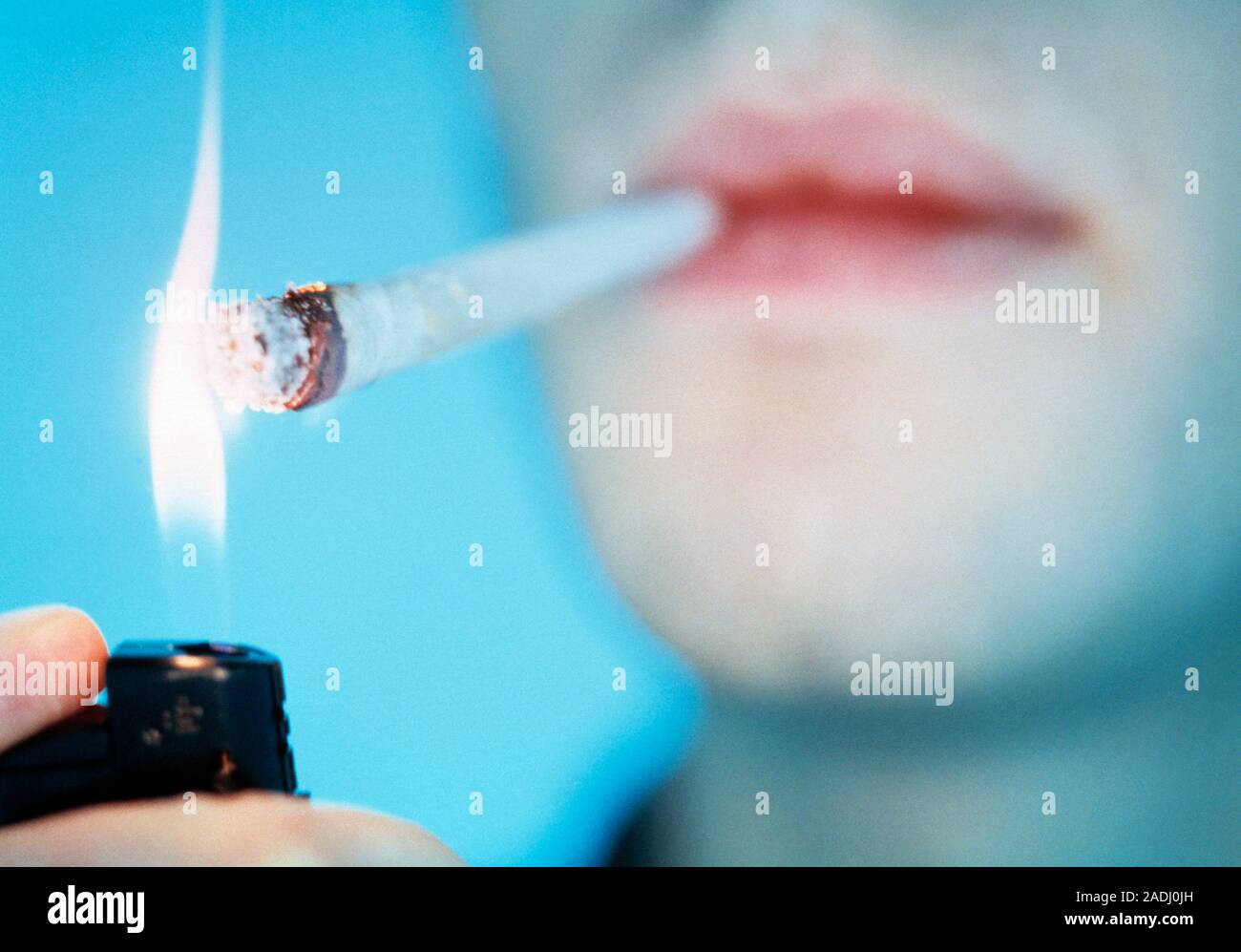 Smoking cannabis. Man lighting a hand-rolled cigarette (joint ...