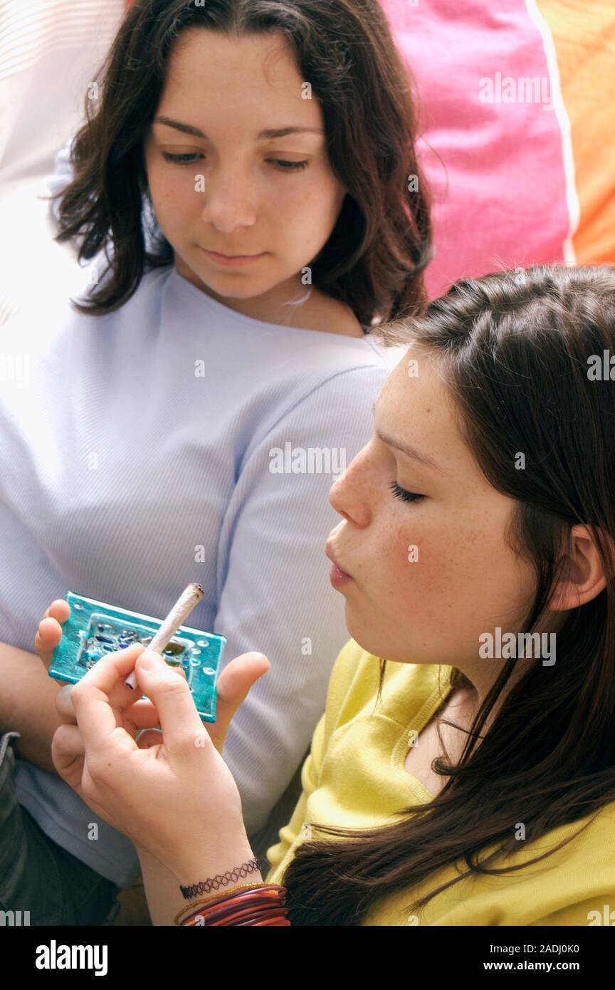 MODEL RELEASED. Cannabis smoking. Two teenage girls smoking a cannabis ...