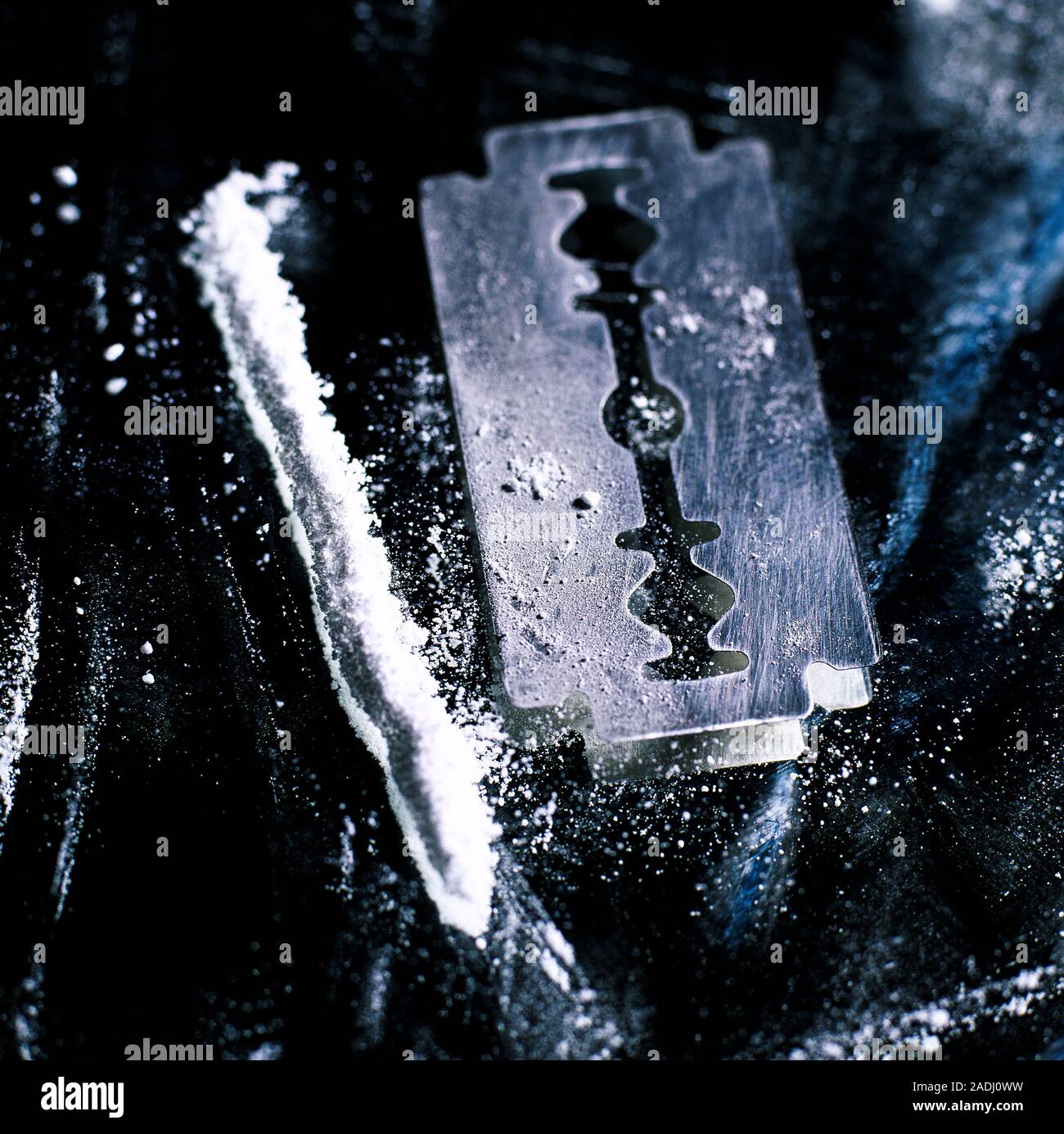 Cocaine. Line of the class A drug cocaine and a razor blade on a mirror ...