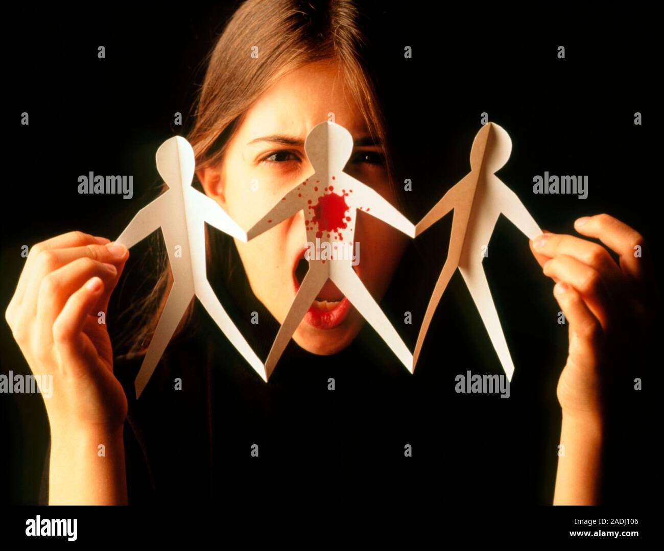 Post-traumatic stress. Conceptual image of a girl holding a paper chain ...
