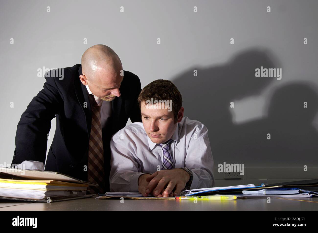 MODEL RELEASED. Office bullying. Manager intimidating a male employee ...