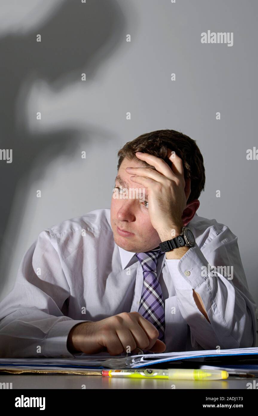 MODEL RELEASED. Office bullying, conceptual image. Worried office ...
