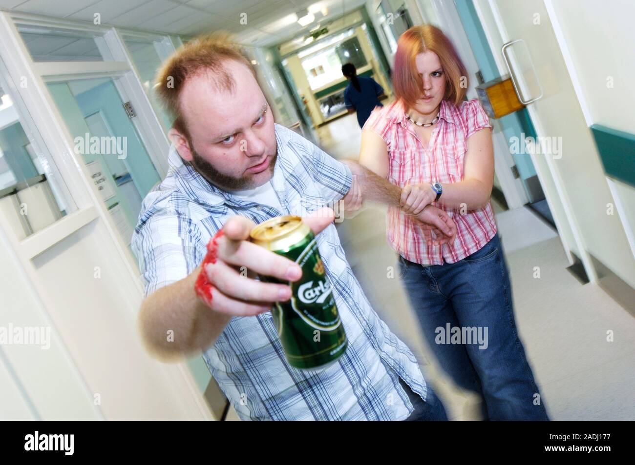 MODEL RELEASED. Violent patient. Aggressive man with a can of beer ...