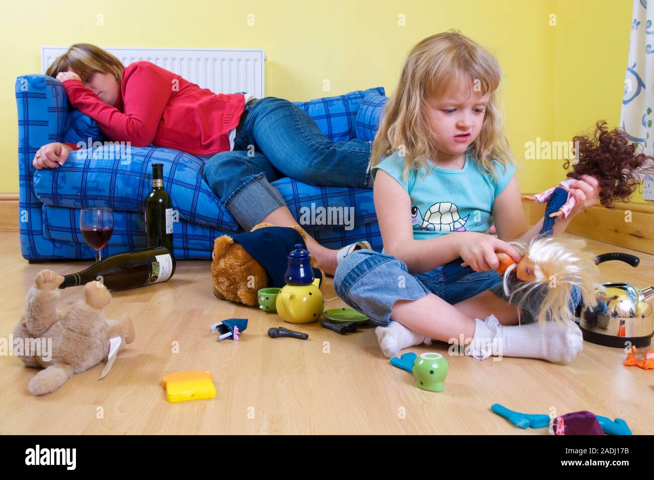 MODEL RELEASED. Child neglect. Young girl making her dolls play fight ...