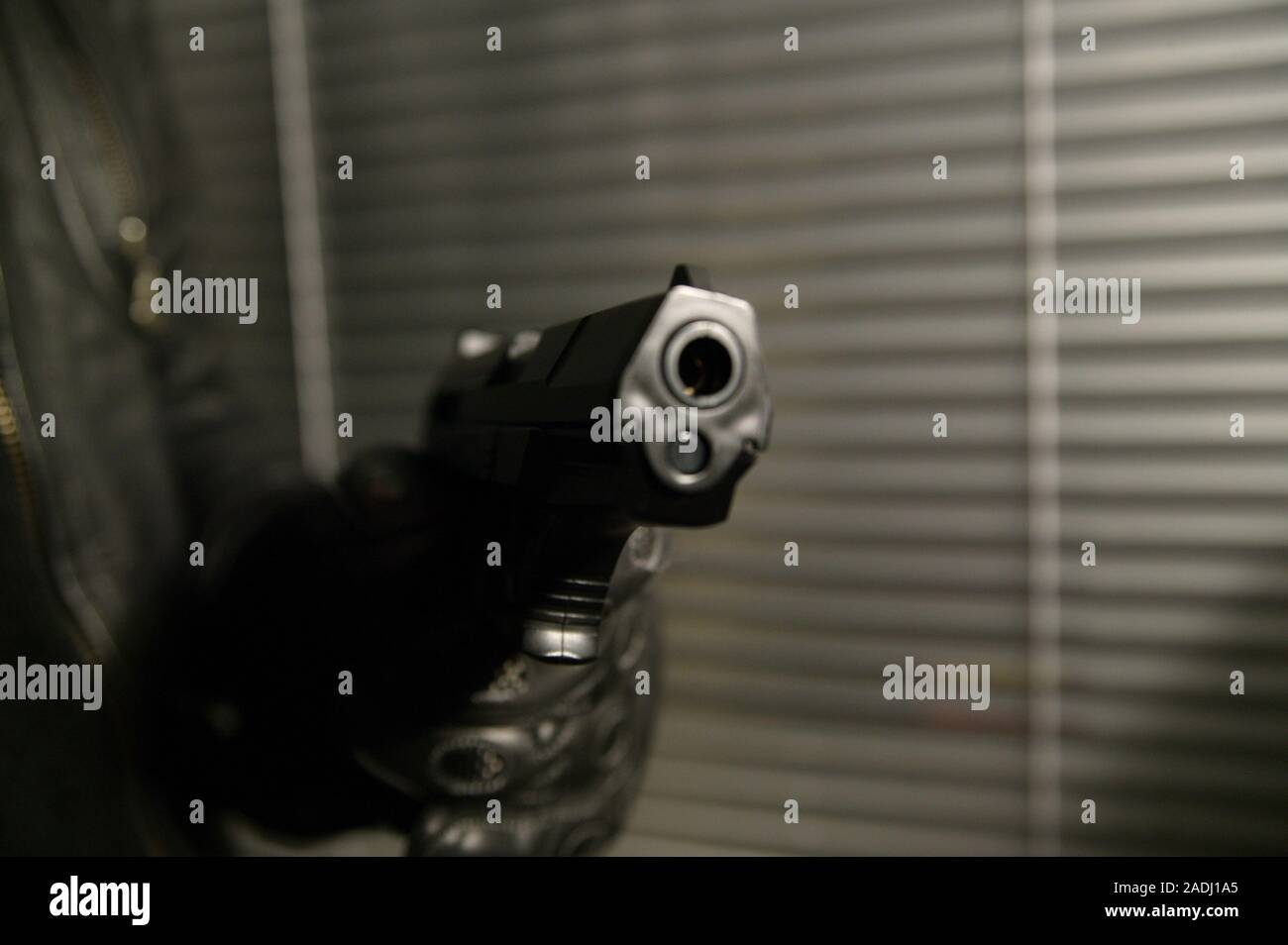 Gun use. Person pointing a gun Stock Photo - Alamy
