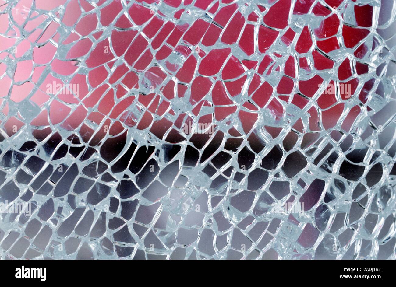 Broken glass. Shattered laminated glass in a telephone box caused ...
