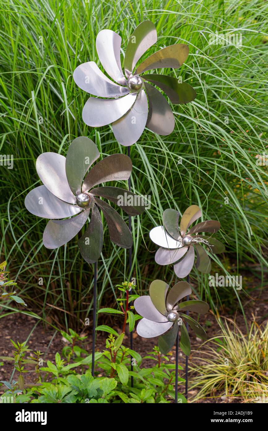 Kinetic garden sculptures in herbaceous border Stock Photo - Alamy
