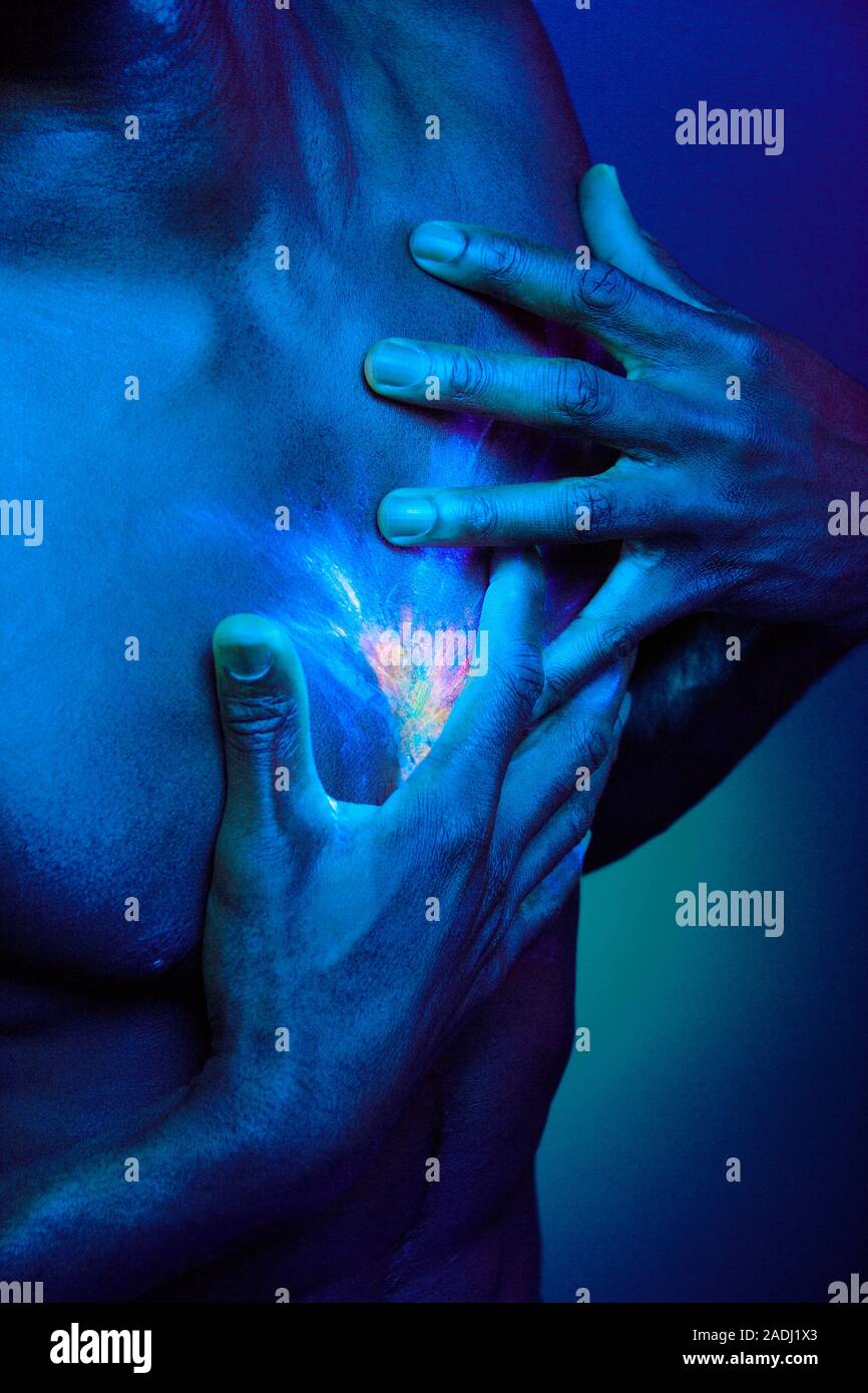 Chest pain. Conceptual image taken in ultraviolet light of a man ...