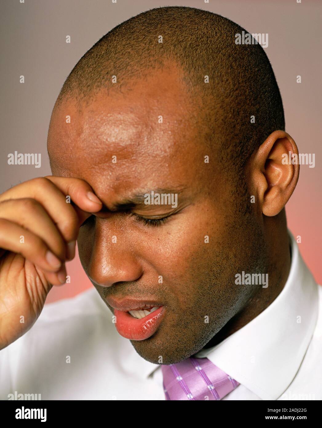 MODEL RELEASED. Headache. Man experiencing pain above his eyebrow. This ...