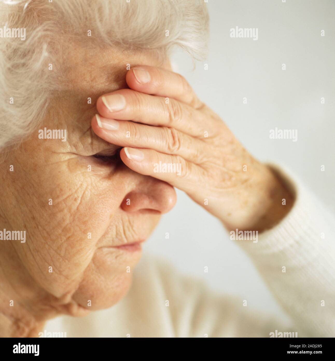 Headache. Elderly woman with a headache pressing her forehead Stock ...