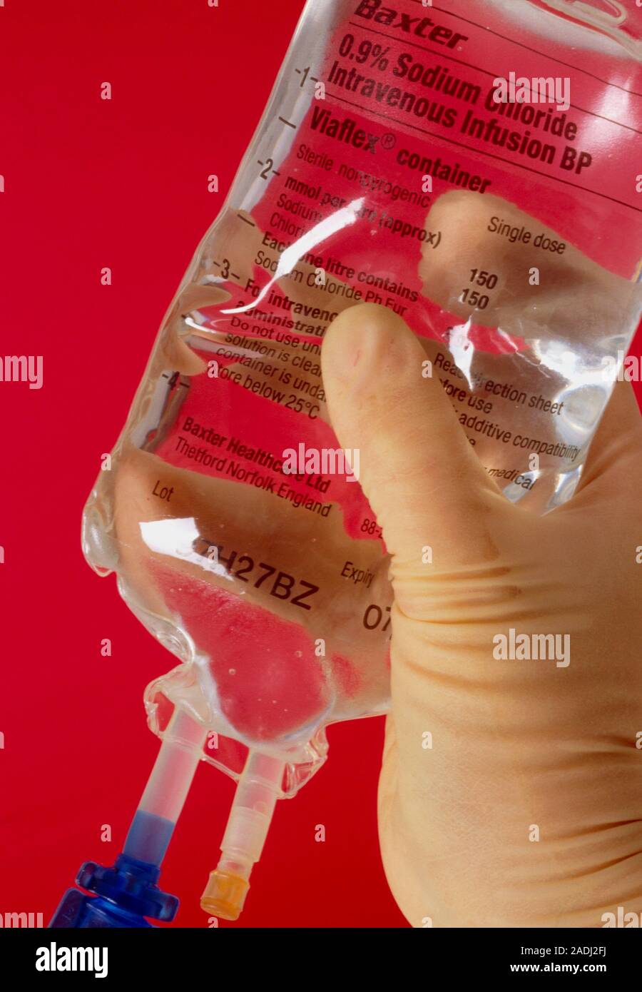 Intravenous drip bag. Gloved hand holding an intravenous (IV) drip bag ... Intravenous drip bag. Gloved hand holding an intravenous (IV) drip bag ...