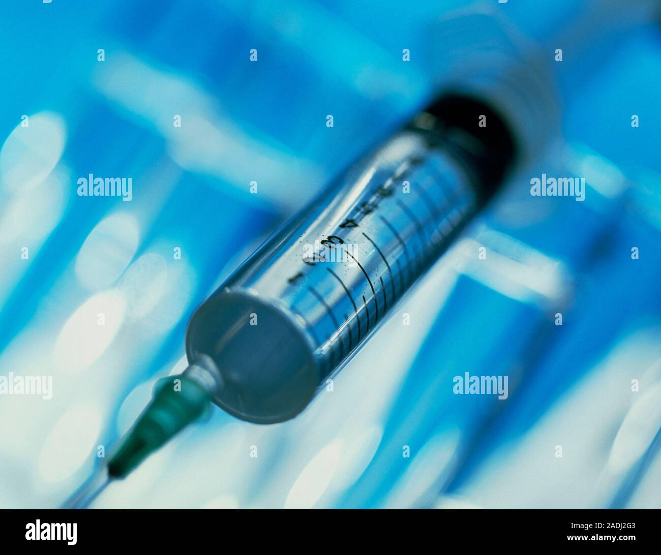 Syringe. View of a hypodermic syringe with a needle attached. The ...