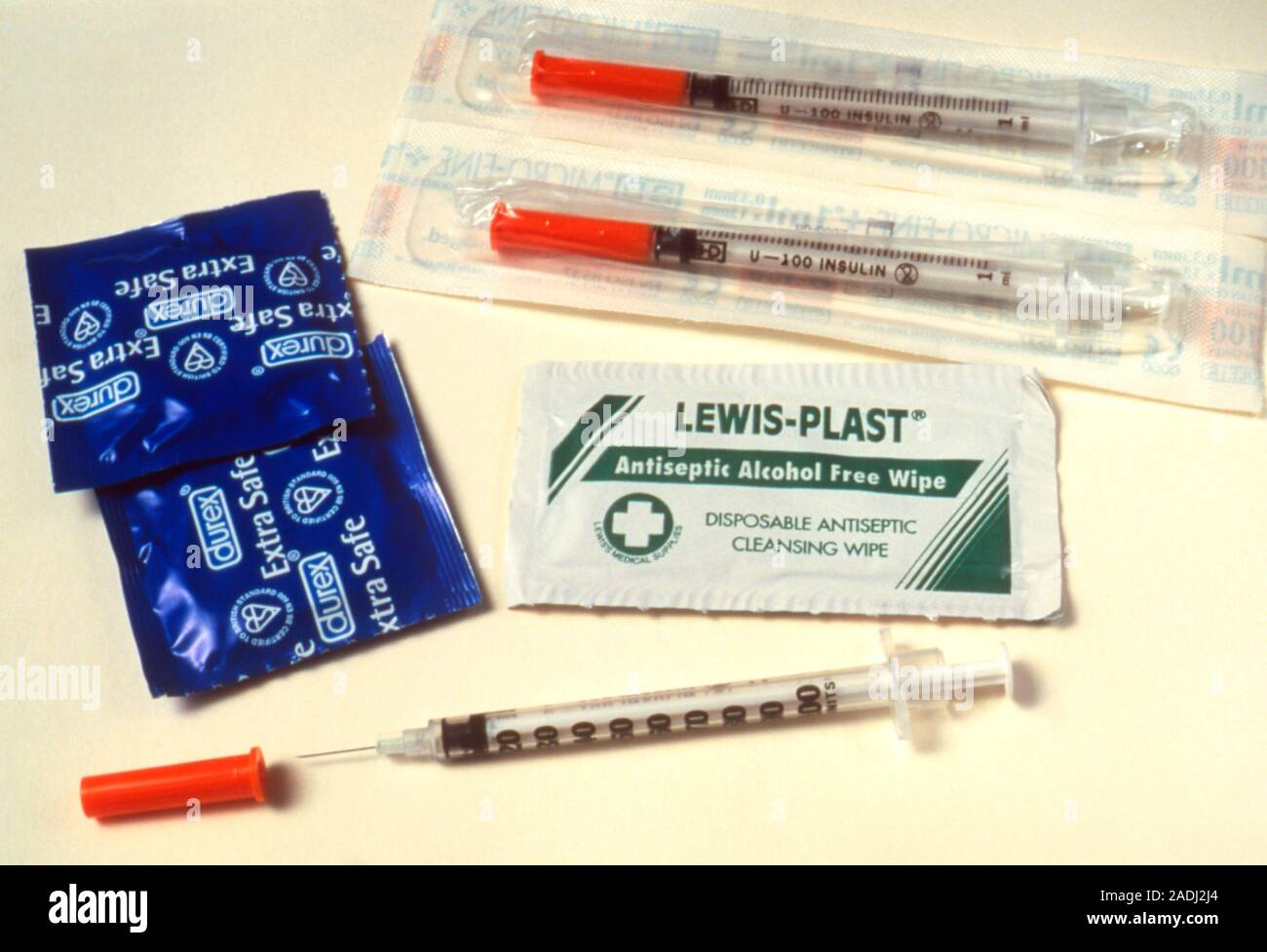Sterile medical equipment. Condoms (centre left), syringes (upper right ...